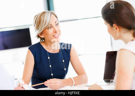 Female manager assessing work of her employees Stock Photo - Alamy