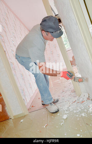 builder knocking wall with hammer Stock Photo - Alamy
