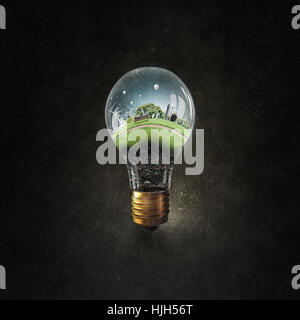 Think green concept with cityscape inside of light bulb Stock Photo - Alamy