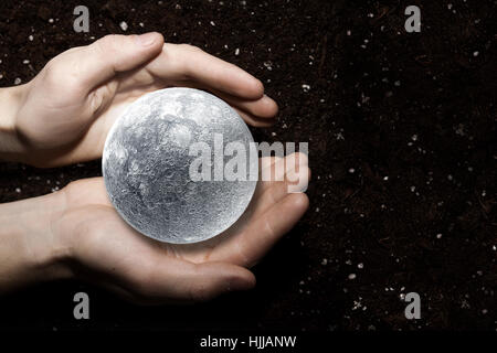 Hands holding moon planet and soil at background Stock Photo - Alamy