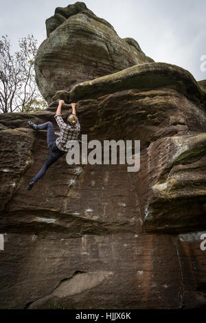A woman bouldering, or rock climbing without ropes, in the Sunderground ...