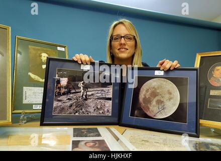 Laura Sykes holds pictures with the signatures of Buzz Aldrin (left ...