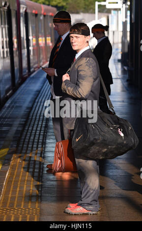 Competitors dressed in suits leave Mudchute DLR station in London after ...