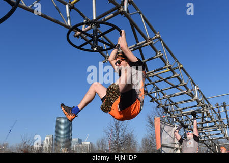 A competitor tackles an obstacle at Mudchute Park and Farm after Tough ...