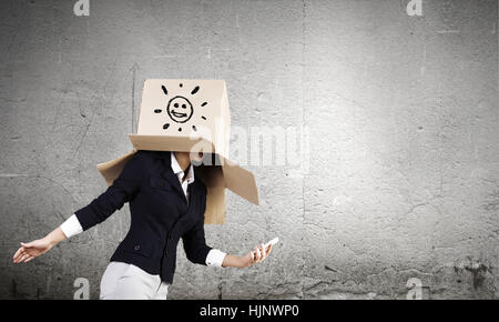 Businesswoman in suit wearing carton box on head Stock Photo - Alamy