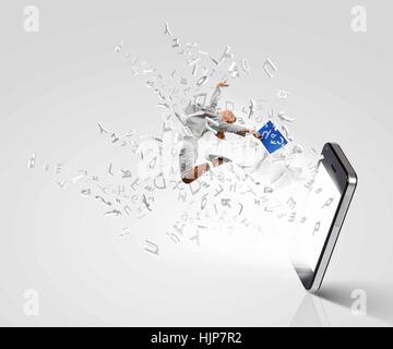 Image of businesswoman jumping out of mobile phone Stock Photo - Alamy