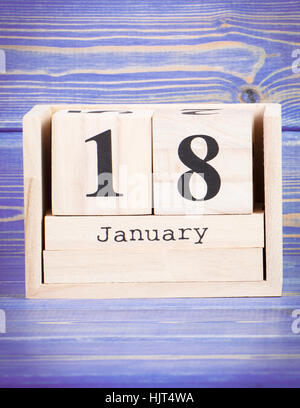 Cube shape calendar for January 18 on wooden surface with empty space ...