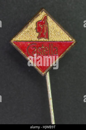 A vintage pin advertising Castella, featuring a washing line design ...