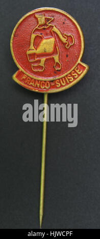 A vintage advertising pin from Franco-Suisse, a Swiss brand known for ...
