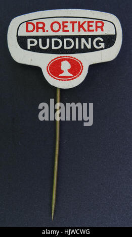A Dr. Oetker pudding advertising pin, a collectible promotional item ...