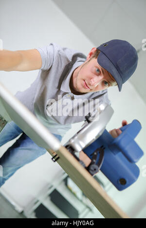 Worker using electric saw portrait Stock Photo - Alamy