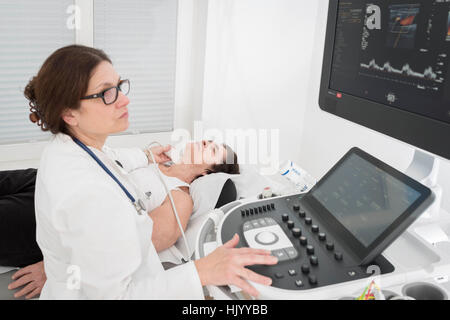 Cardiologist performing echocardiogram on senior female patient Stock ...