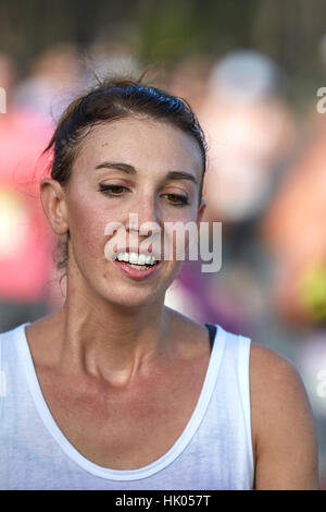 Marathon runners are seen close to the finish line running through the ...