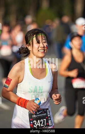 Marathon runners are seen close to the finish line running through the ...