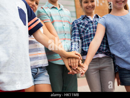 group of happy kids putting hands together Stock Photo - Alamy