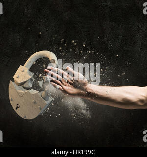 Image of human hand breaking stone lock Stock Photo - Alamy