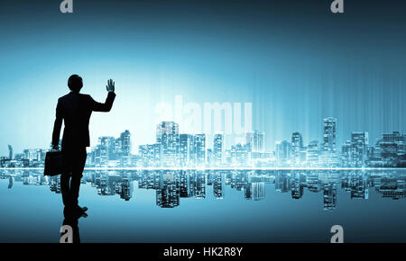 Businessman standing with back against night city panoramic view Stock ...