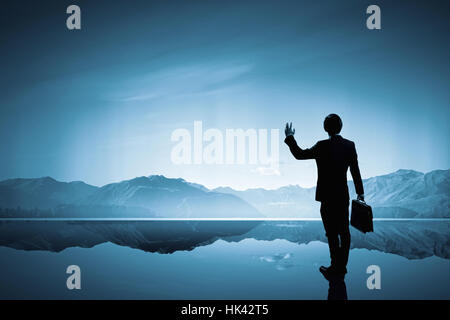Rear view of businessman looking at picturesque nature landscape Stock ...