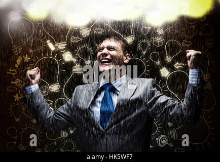 Cheerful businessman with hands up celebrating success Stock Photo - Alamy