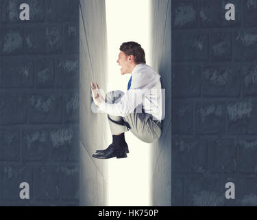 Young troubled businessman trapped between two walls Stock Photo - Alamy