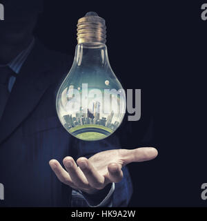 Think green concept with modern cityscape inside of light bulb Stock ...