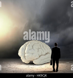 Rear view of businessman looking at big brain model Stock Photo - Alamy