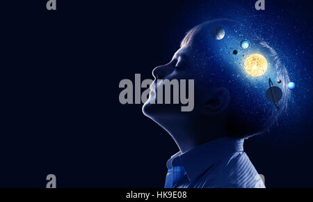 Cute boy of school age exploring space system Stock Photo - Alamy