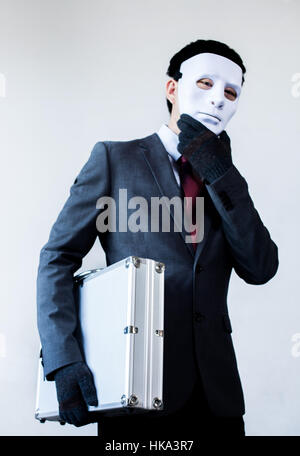 The businessman wearing mask in hypocrisy concept Stock Photo - Alamy