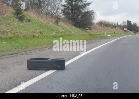 Remould (retread) tyre on the hard shoulder of A1(M) beside broken down ...