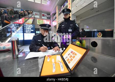 Changchun, China. 26th Jan, 2017. Police officers Gao Yang (C-R) and ...