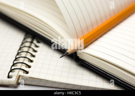 Pencil on the pages of an open notebook Stock Photo - Alamy
