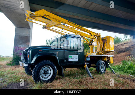 Land Rover vehicle with cherry picker crane mounted on its back rented ...