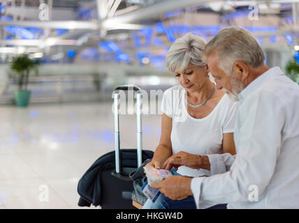 Senior couple traveling airport scene Stock Photo - Alamy