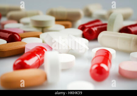 Medical theme. Plenty of red and other pills and capsules. Closeup ...