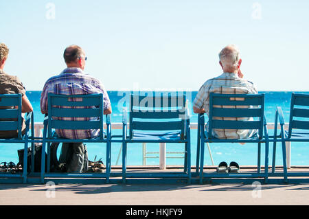Men sit on benches in a London park during warm, sunny weather, as the ...