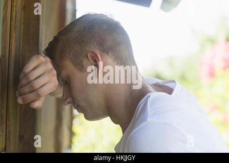 a man banging his head against the wall in frustration Stock Photo - Alamy