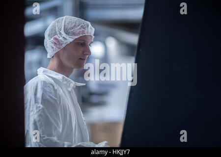 Man in a clean-room suit holding a computer processor Stock Photo - Alamy