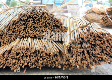 rusty rebar rods lie in a pile near the construction site of the ...