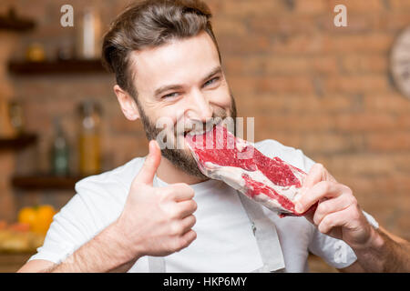 man eating raw meat Stock Photo - Alamy