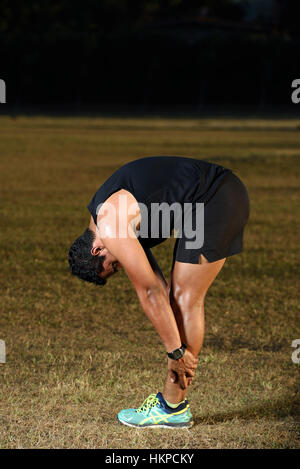 Handsome hispanic man stretching at the gym Stock Photo - Alamy