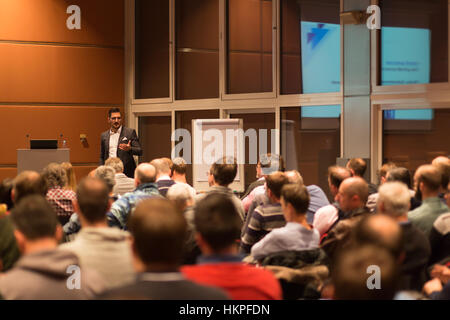 Businessman speaker giving talk on corporate business meeting in ...