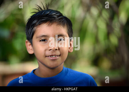 Headshot of latino boy with smile in garden Stock Photo - Alamy