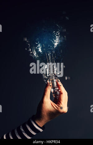 Female hand with glowing light bulb on green background Stock Photo - Alamy