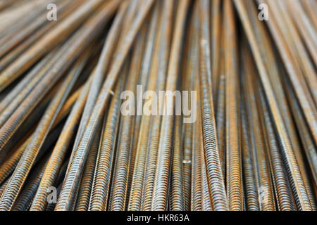 rusty rebar rods lie in a pile near the construction site of the ...