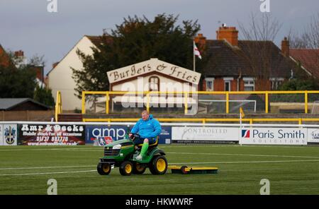Sutton United Goalkeeper Wayne Shaw attends to the artificial pitch ...