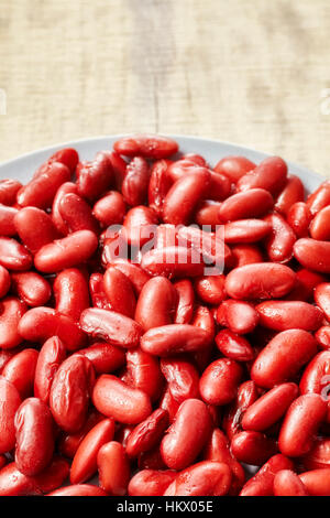 Close up of cooked red kidney beans in a terracotta bowl on a rustic ...