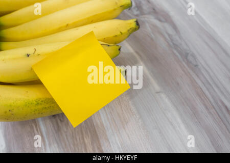 Banana with Sticky Note on wood table Stock Photo - Alamy