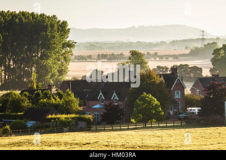 A typical English summer scene with rolling hillsides and sheep grazing ...