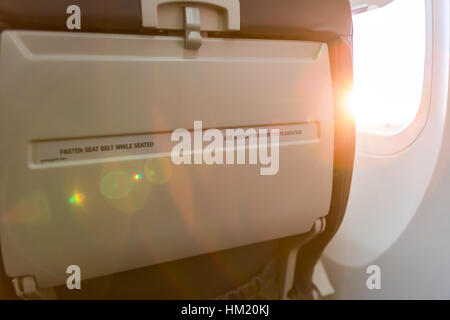 Warning sign on back of airline seat Stock Photo - Alamy