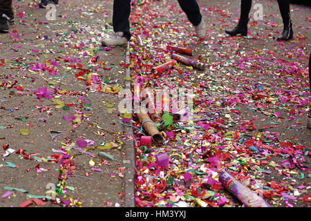 Spent giant party poppers, confetti and glitter litter a NYC Chinatown ...